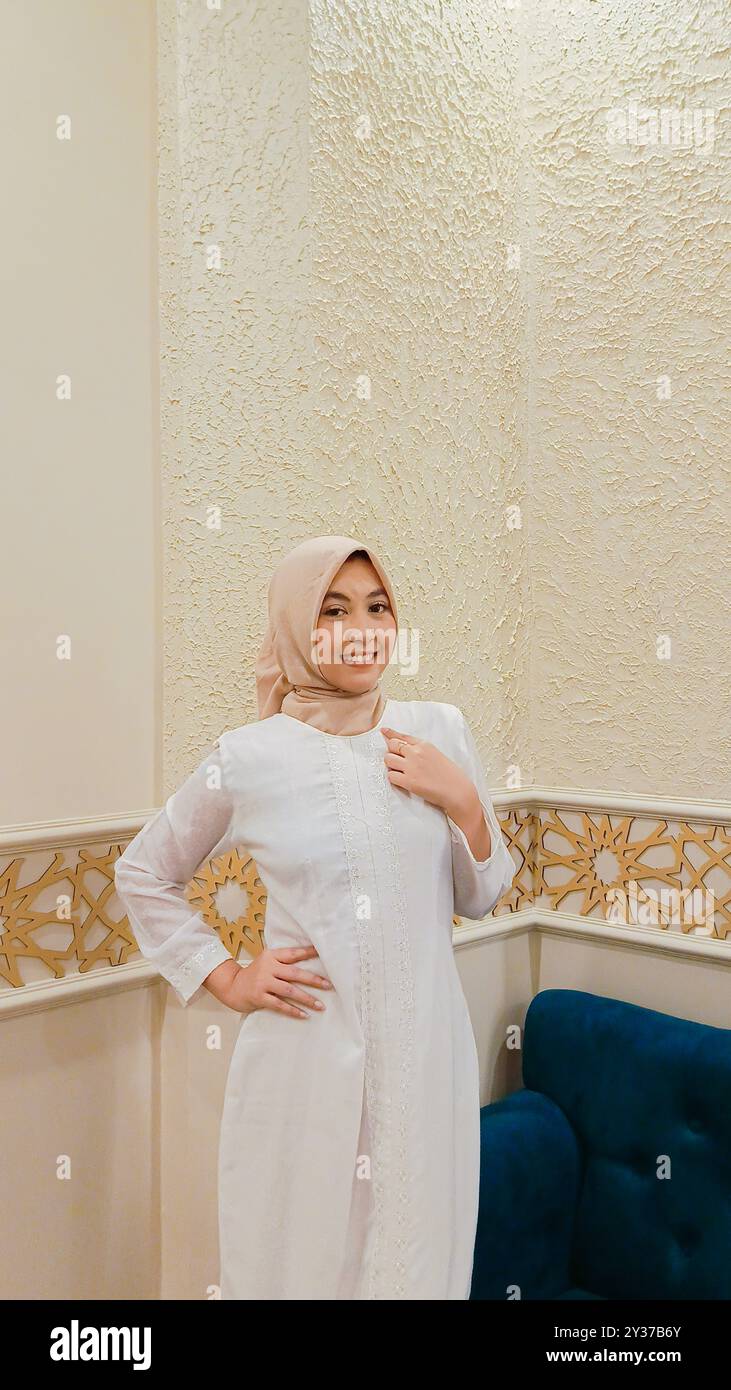 the charm of an Asian woman wearing a hijab, a cheerful smiling ...