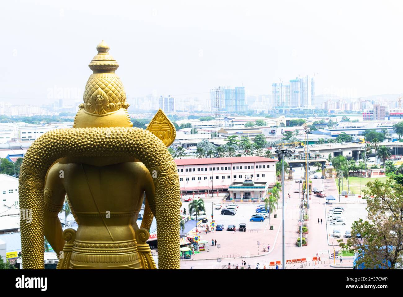 Golden hindu god statue watching over the cityscape of kuala lumpur ...