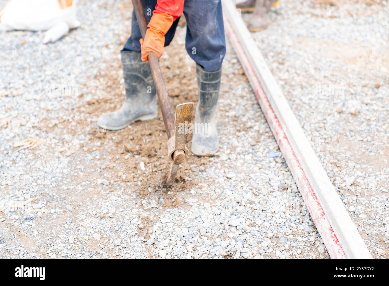 Worker digging a floor with a pickaxe in construction site Stock Photo ...