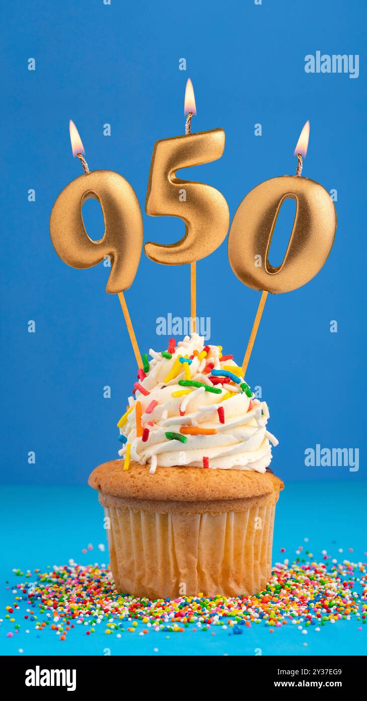 Candle number 950 - Cupcake birthday in blue background Stock Photo - Alamy