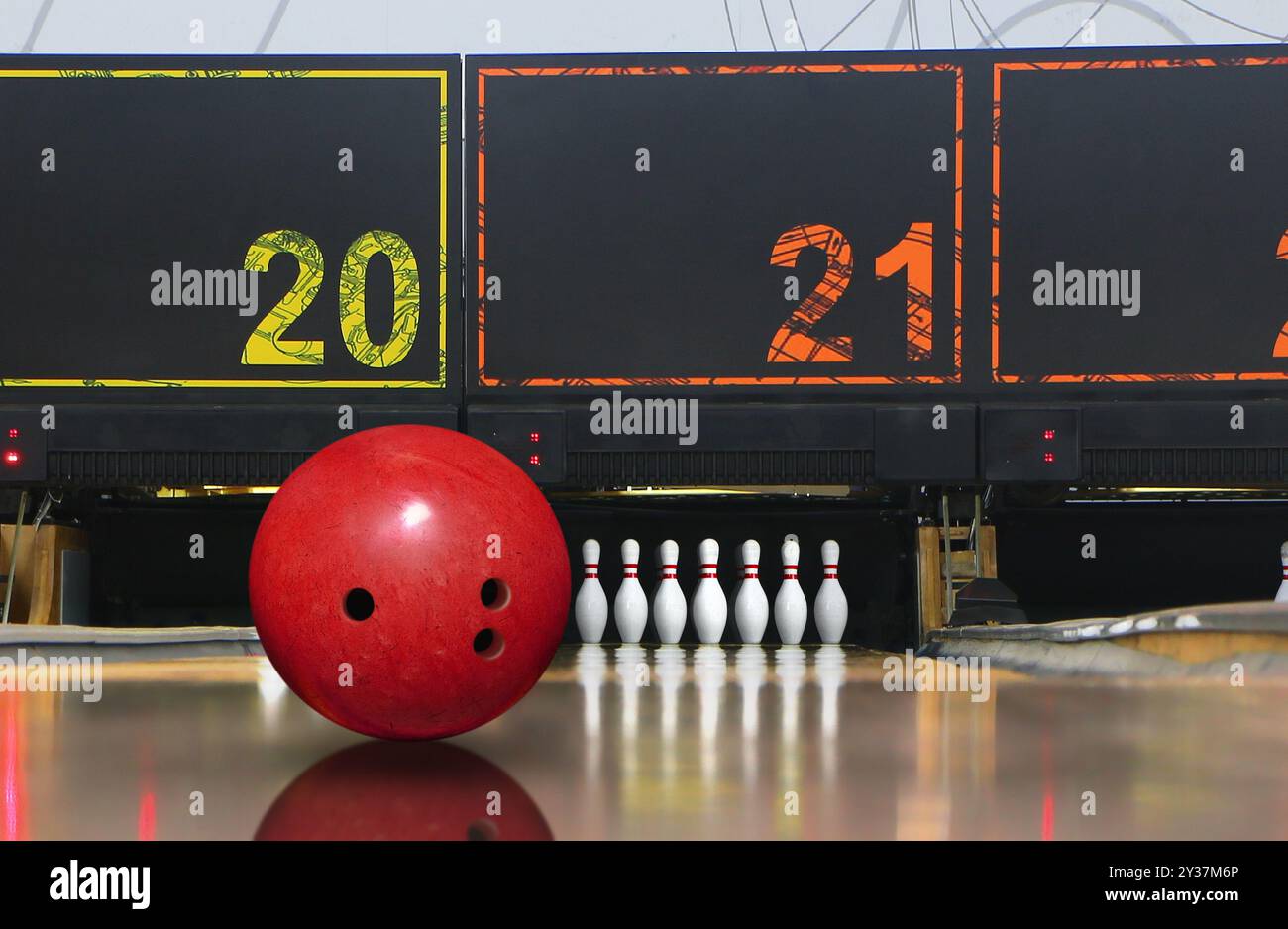 Bowling ball rolling on lane with tenpin in background Stock Photo - Alamy