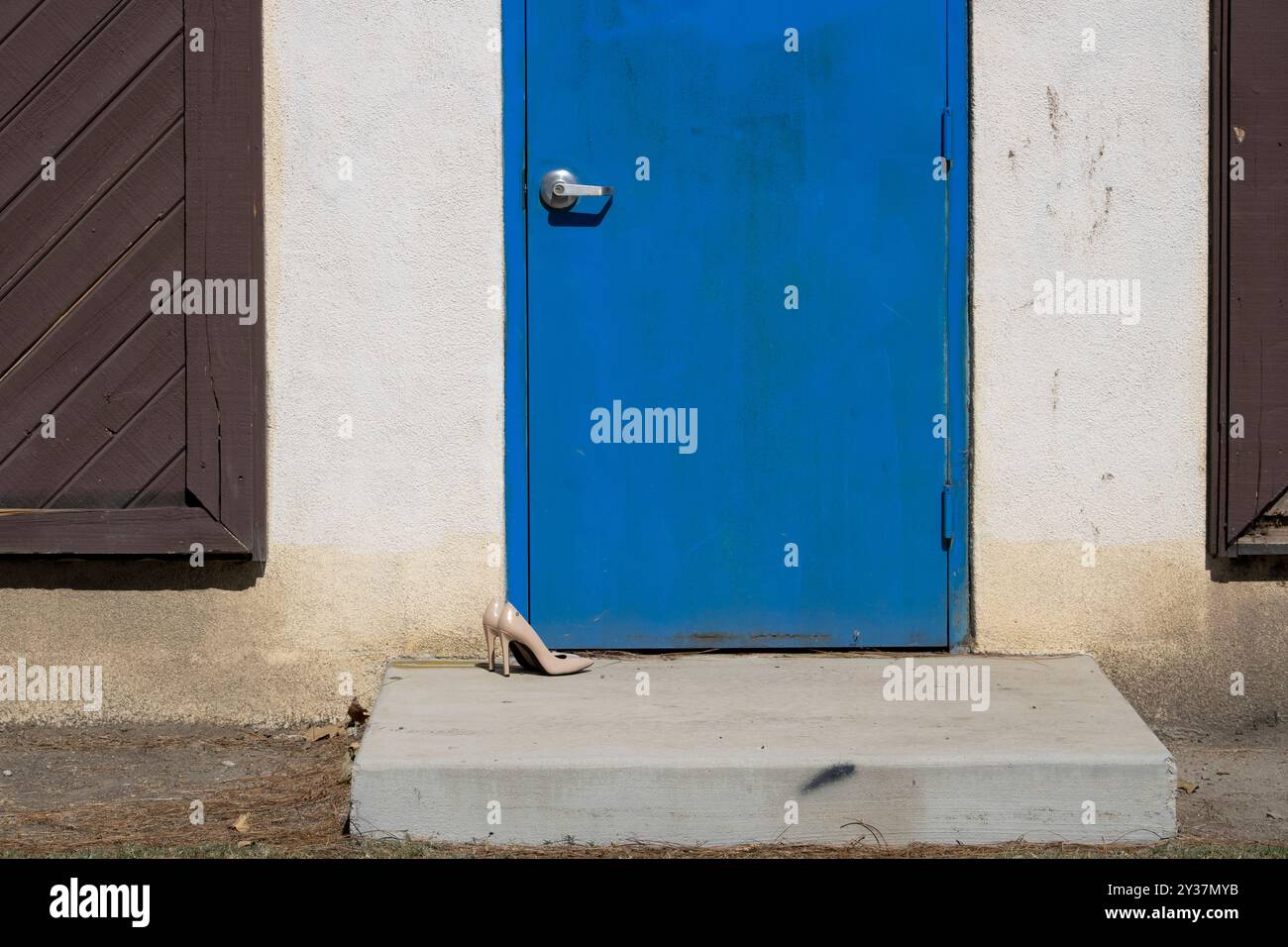 beige high heel shoes outside blue door Stock Photo - Alamy