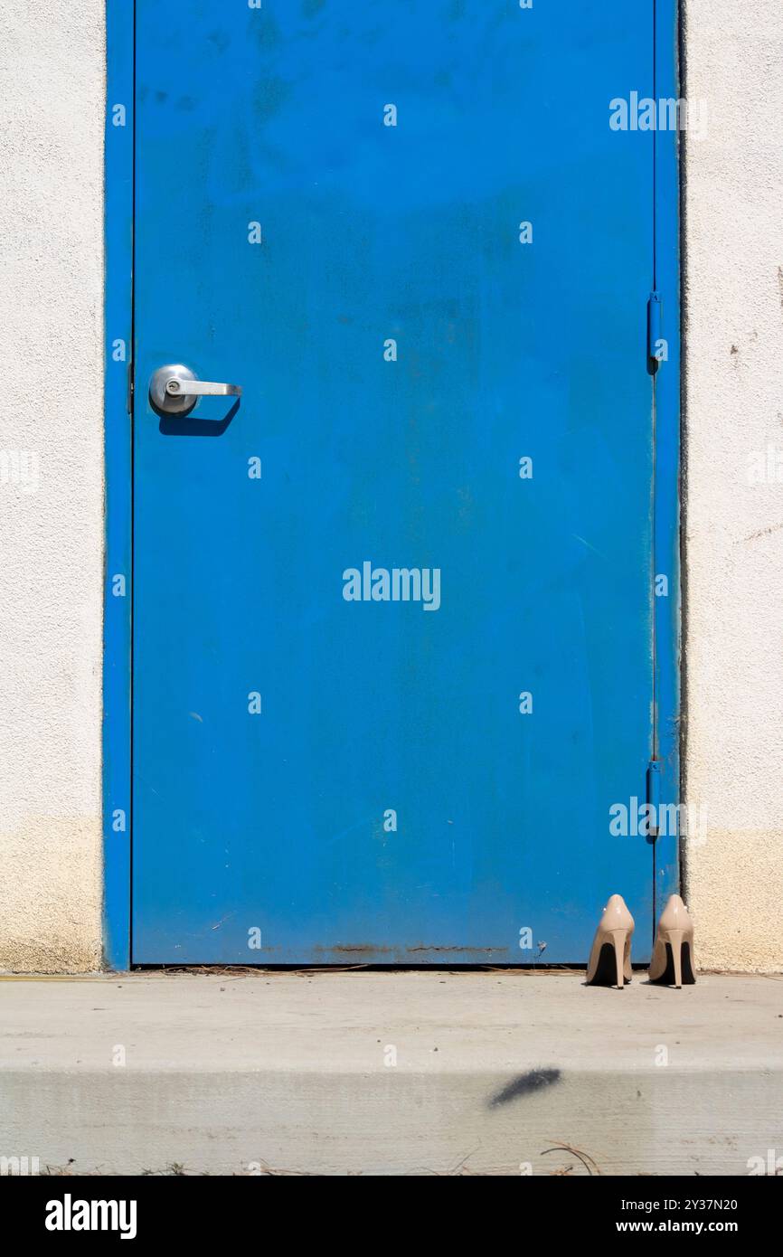 beige high heel shoes outside blue door Stock Photo - Alamy