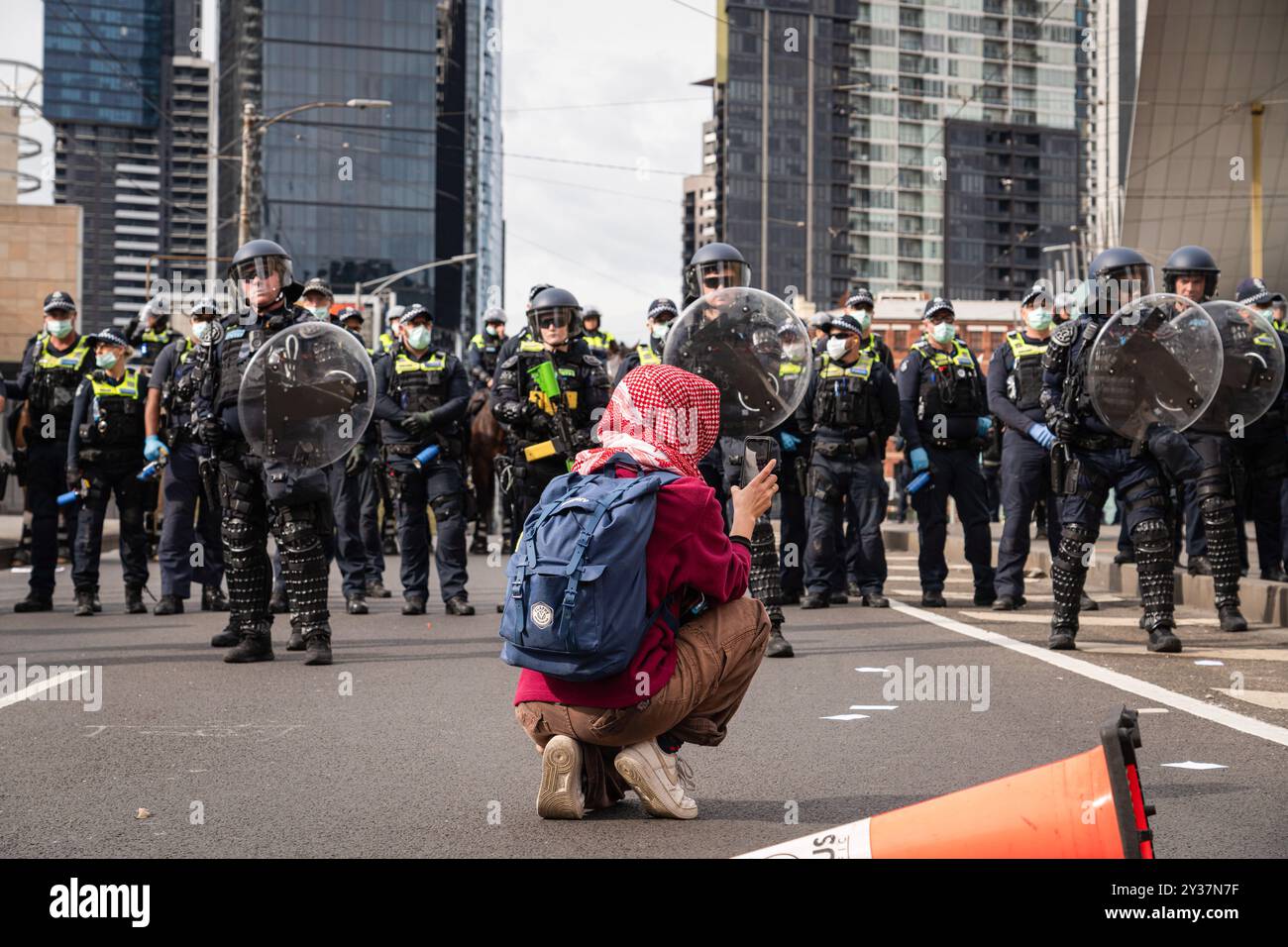 Melbourne, Australia 11/09/2024, a protester kneels in front of police ...