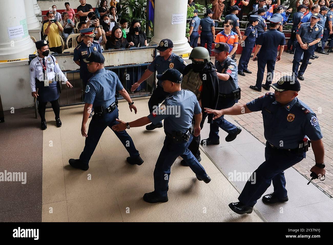 Apollo Carreon Quiboloy, wearing a helmet and flak jacket, a Filipino ...
