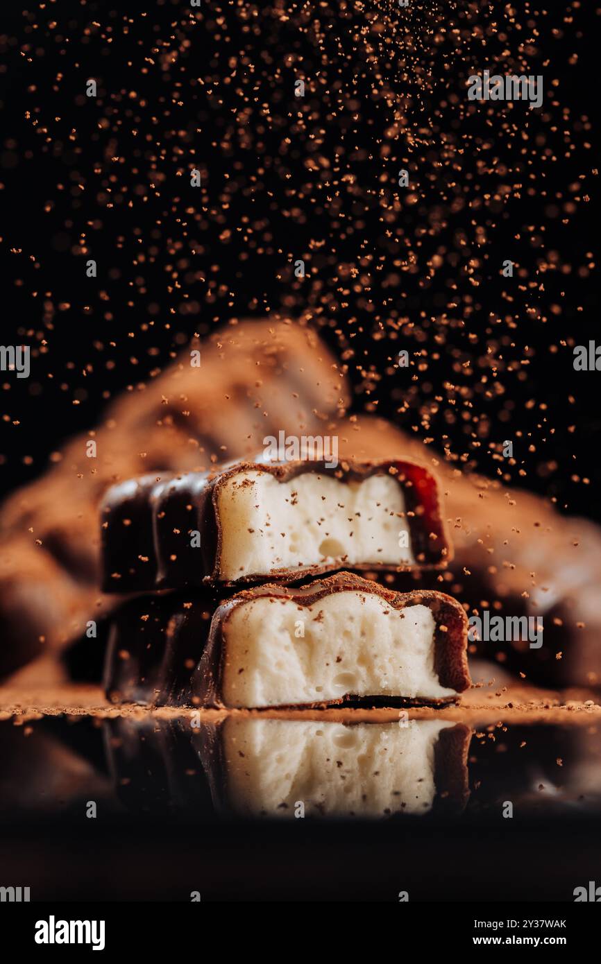 Chocolate bars with cocoa powder sprinkle on dark background ...