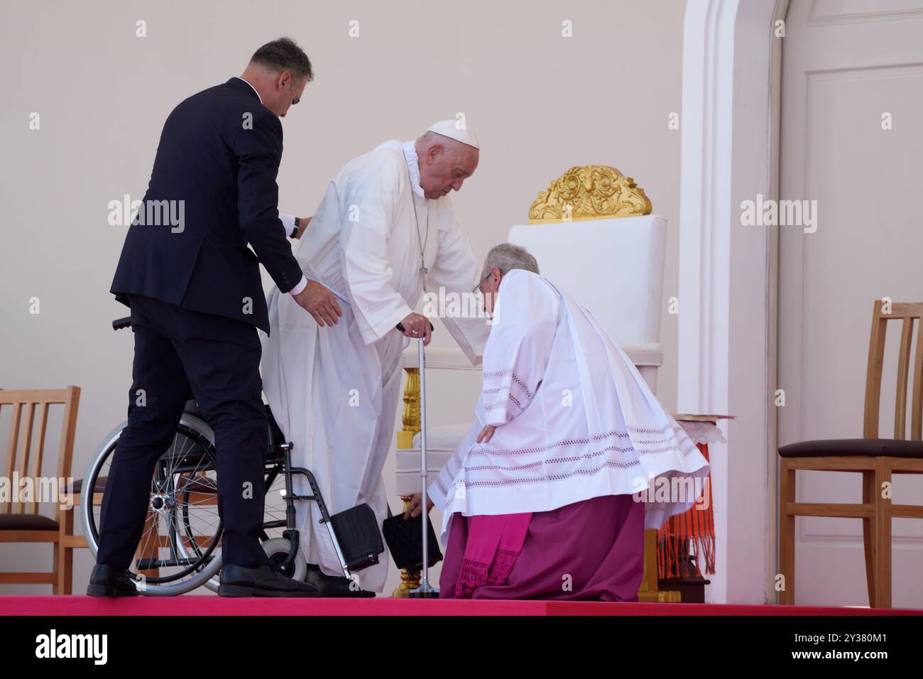 Pope Francis is helped by his aide Archbishop Diego Ravelli, right, as ...