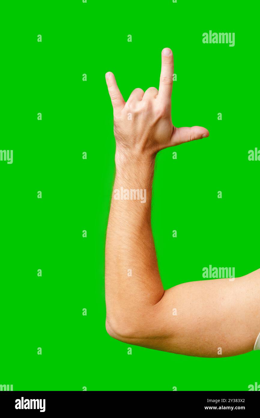 Person Making Hand Gesture Against Bright Green Background in Daylight ...