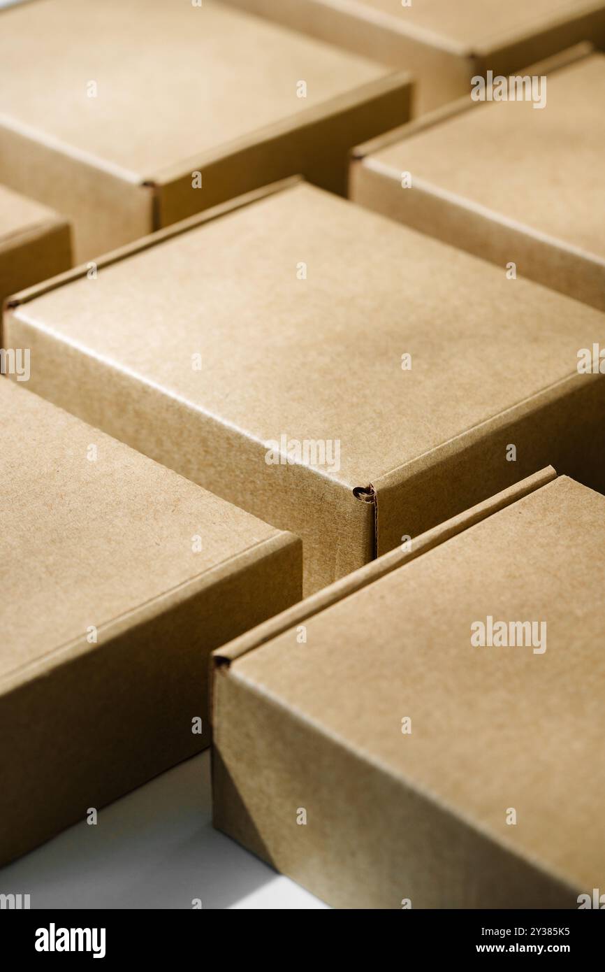 Brown cardboard boxes arranged on a neutral background in a warehouse ...