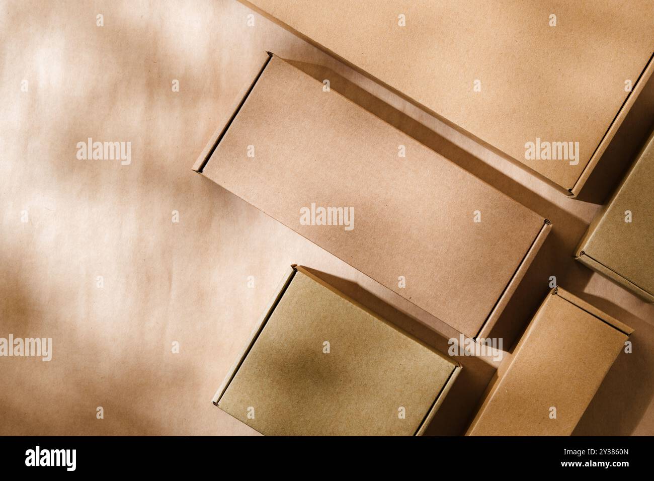 Brown cardboard boxes arranged on a neutral background in a warehouse ...
