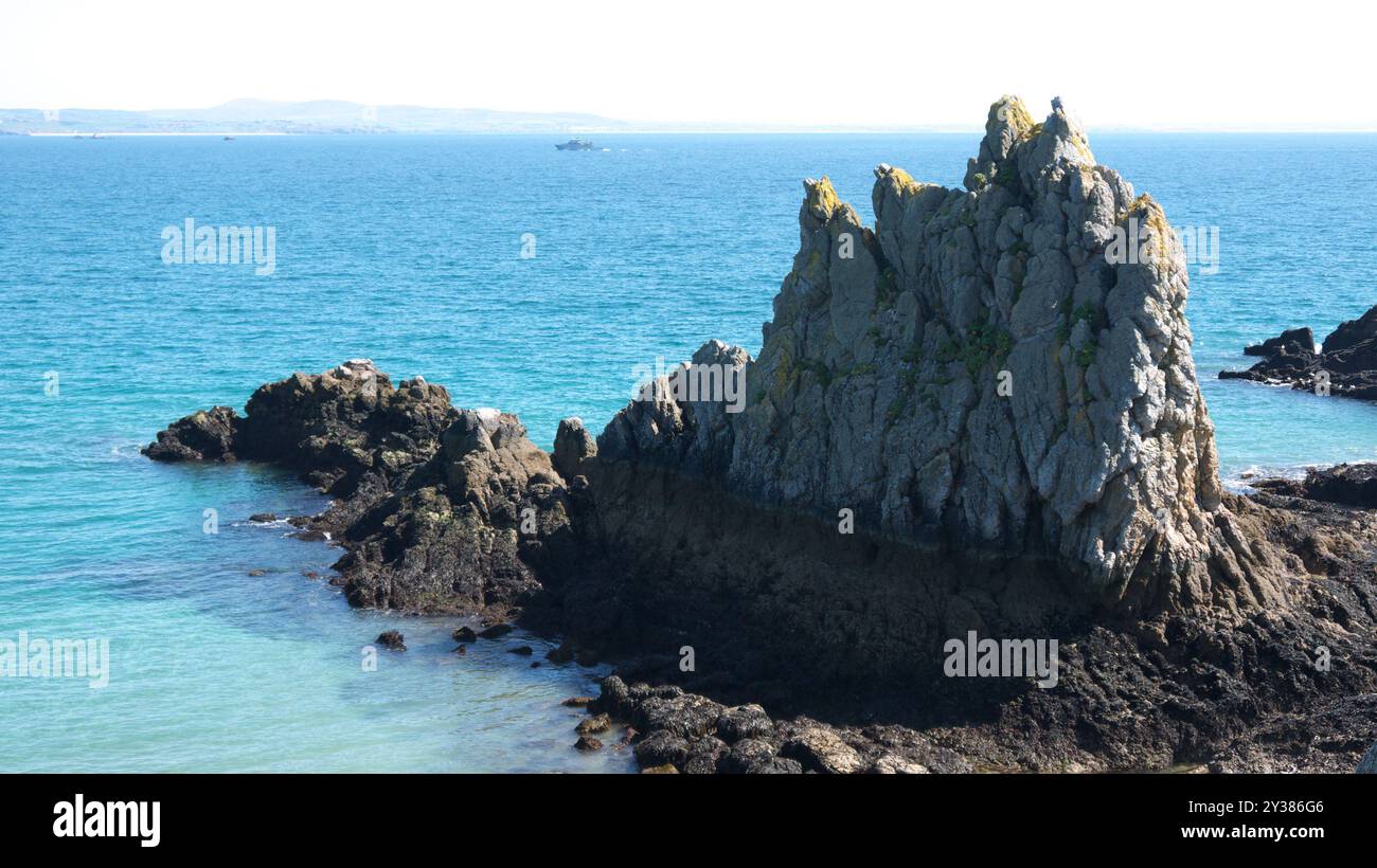 A striking cliff resembling a tall, rugged wall juts out into the ...