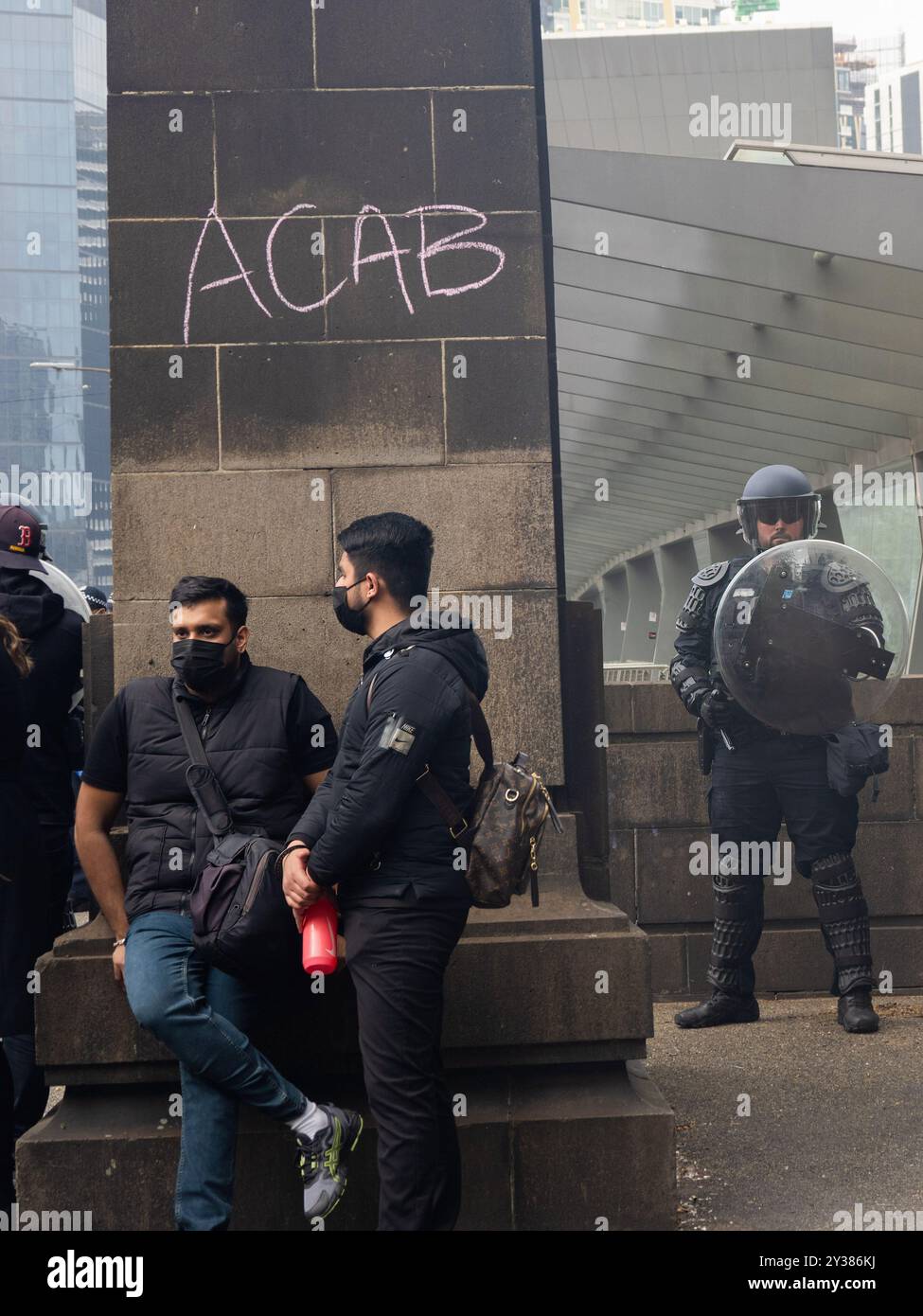 A Victoria Police Public Order Response Team officer is seen with a ...