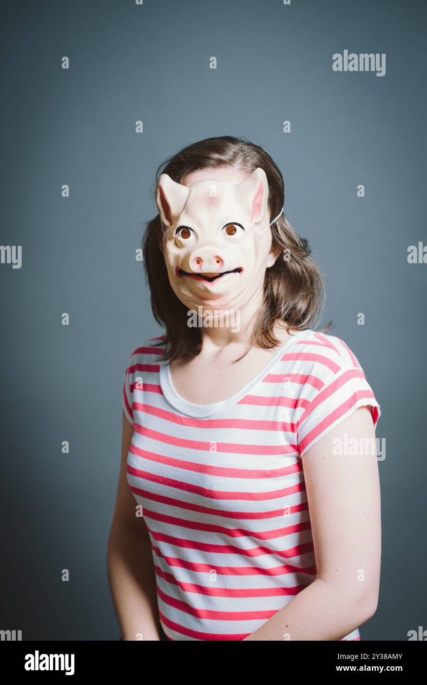 Studio, portrait and woman with pig mask for character, facade and ...