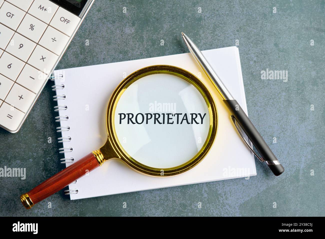 Letters of the alphabet with words PROPRIETARY through a magnifying ...