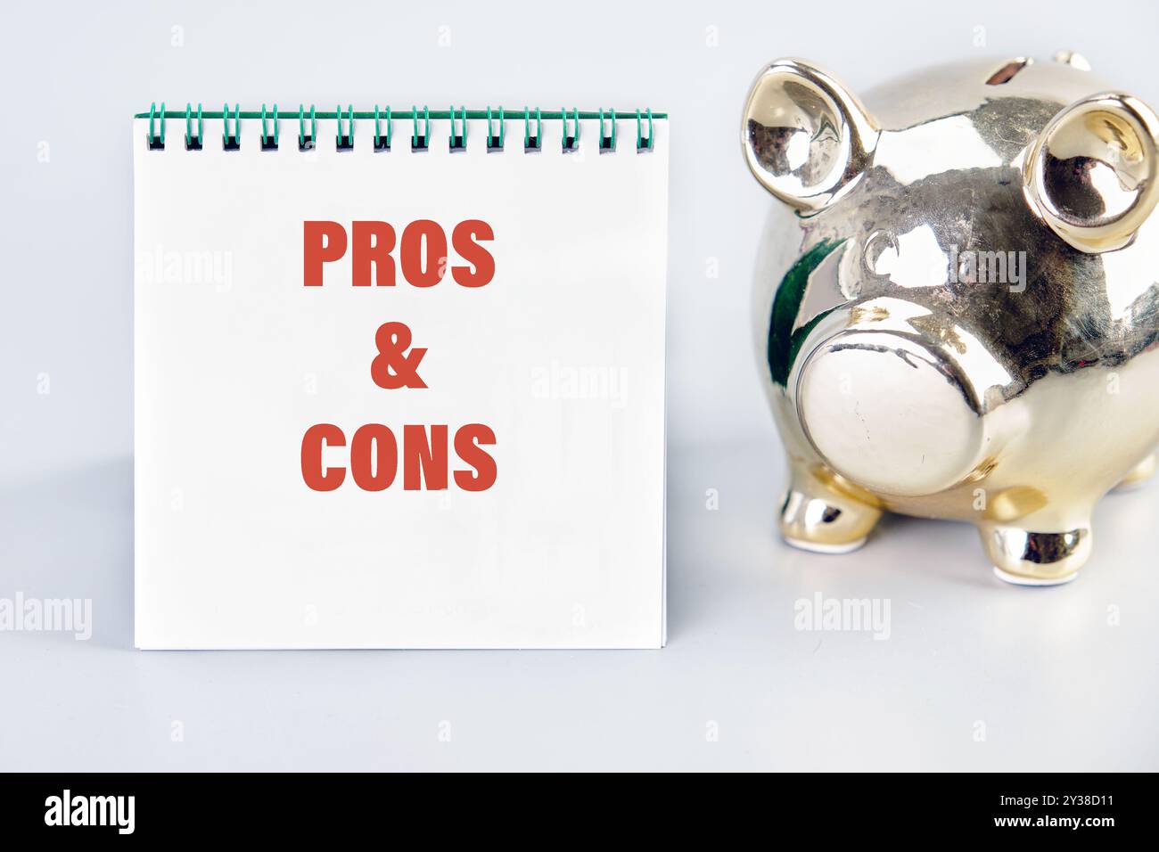 PROS and CONS message on a white notebook, front view on a gray ...