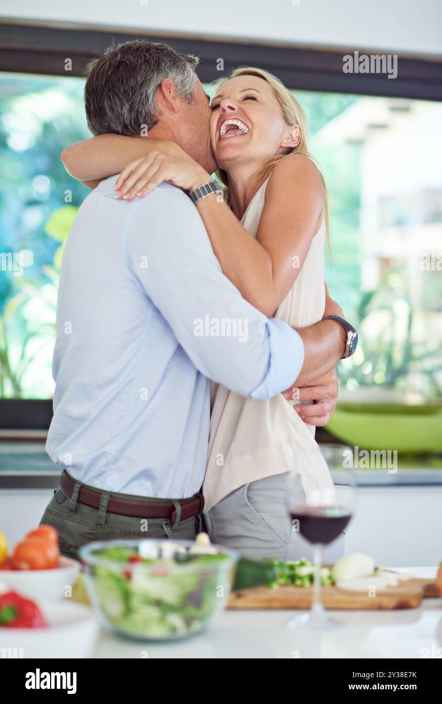 Cooking, hug and funny with couple in kitchen for healthy lunch ...