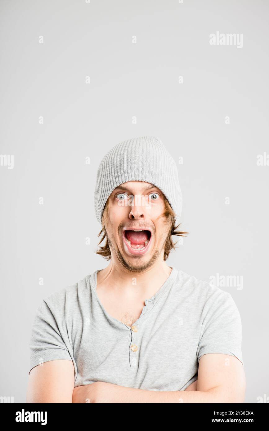 Man, portrait and scary shouting in studio, mental health and alert for ...