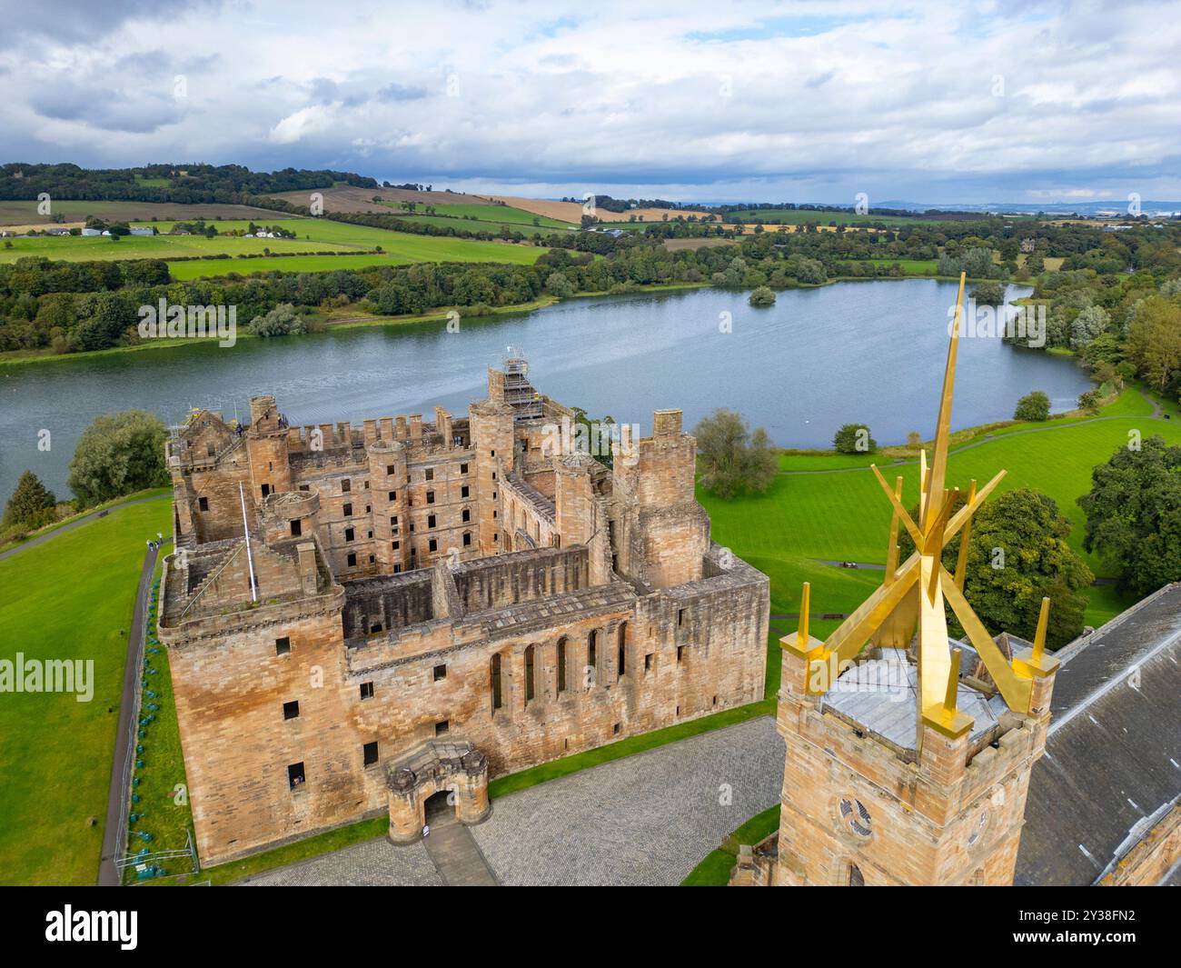 Aerial view from drone of Linlithgow Palace and steeple of St Michaels ...