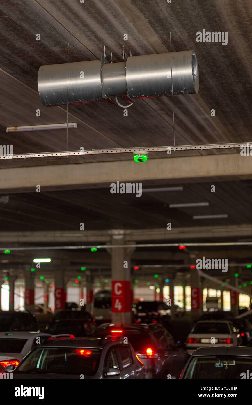 Neon multi-level underground parking in a shopping center. Covered ...