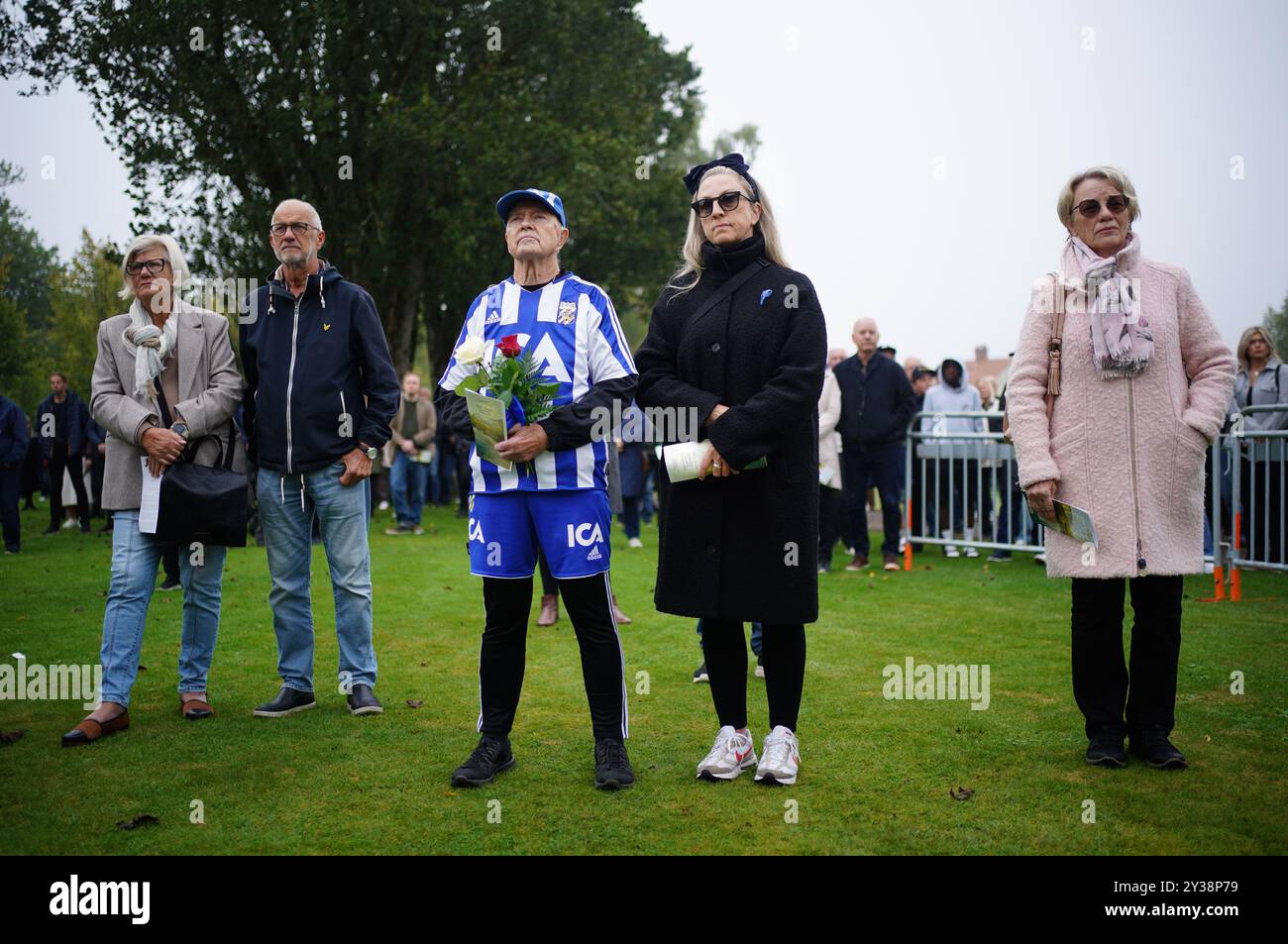 A person wearing a IFK Goteborg football kit pays respects outside the ...
