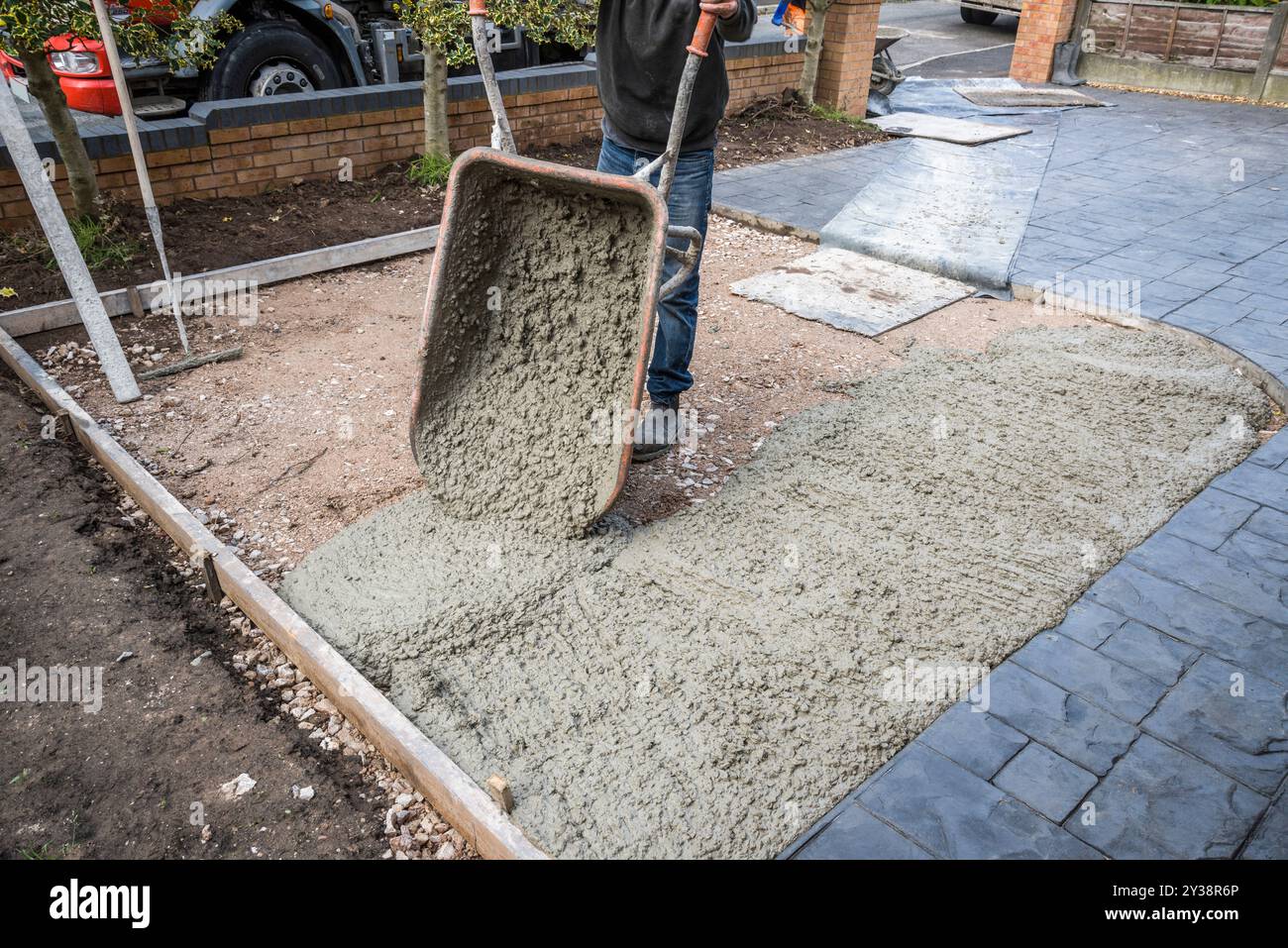 work men pouring concrete creating a new concrete driveway Stock Photo ...