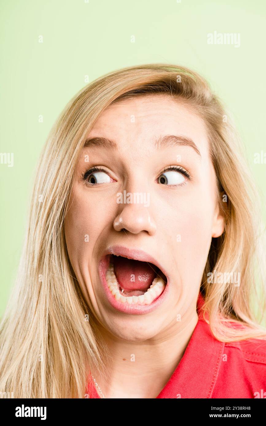 Woman, surprise and funny face with goofy expression for humor or ...