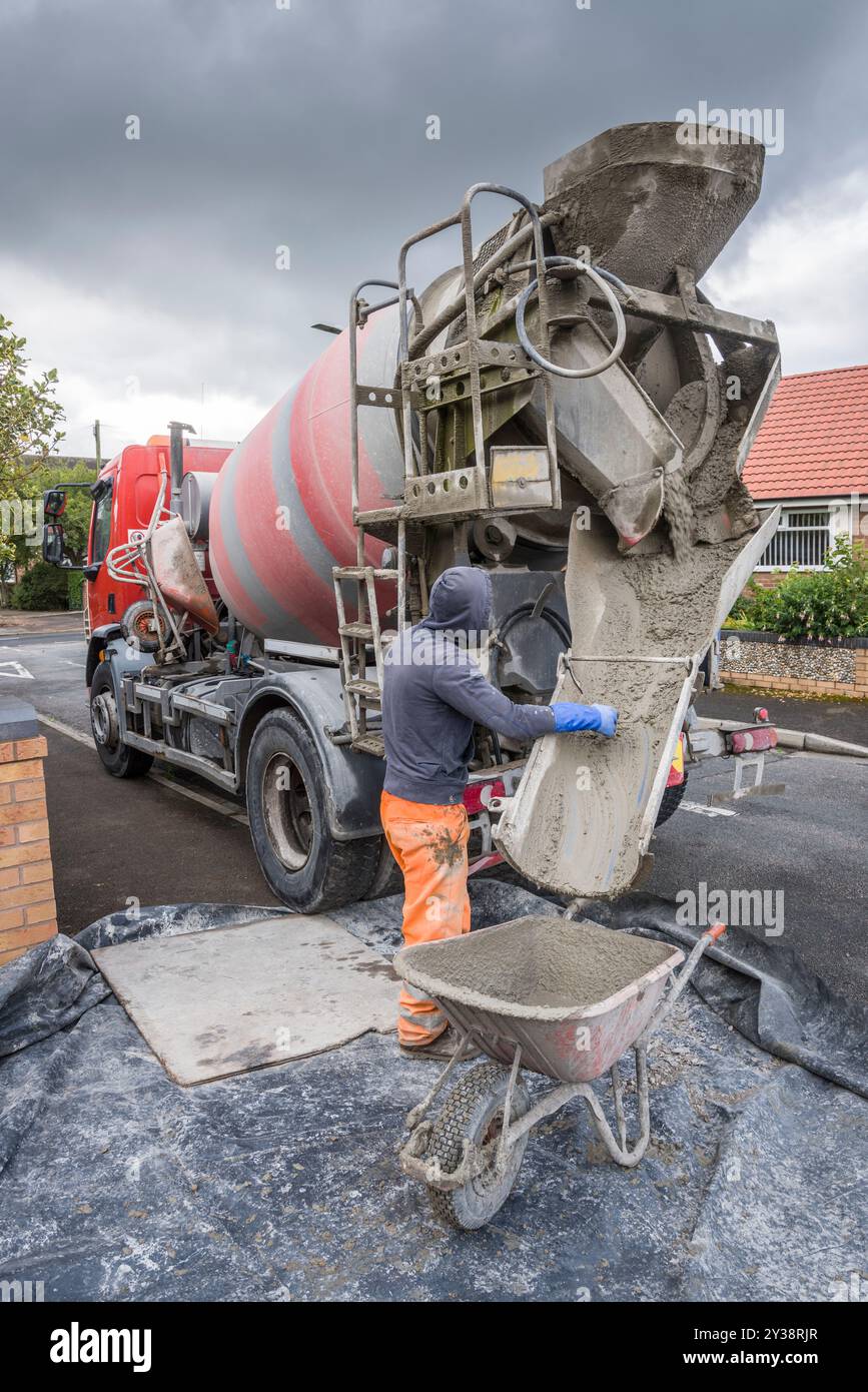 work men pouring concrete creating a new concrete driveway Stock Photo ...