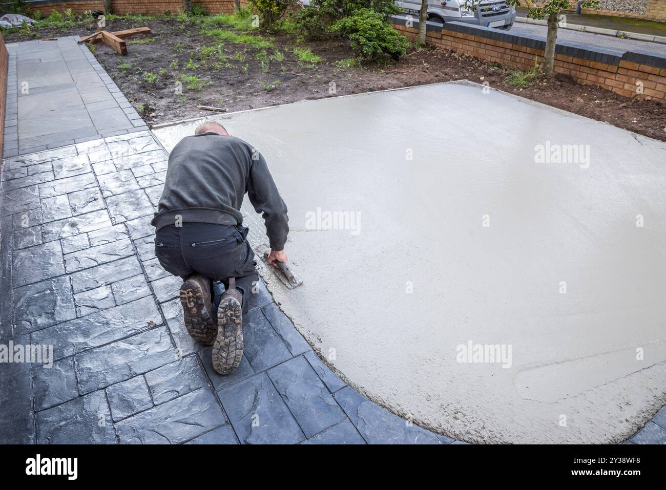 work men pouring concrete creating a new concrete driveway Stock Photo ...