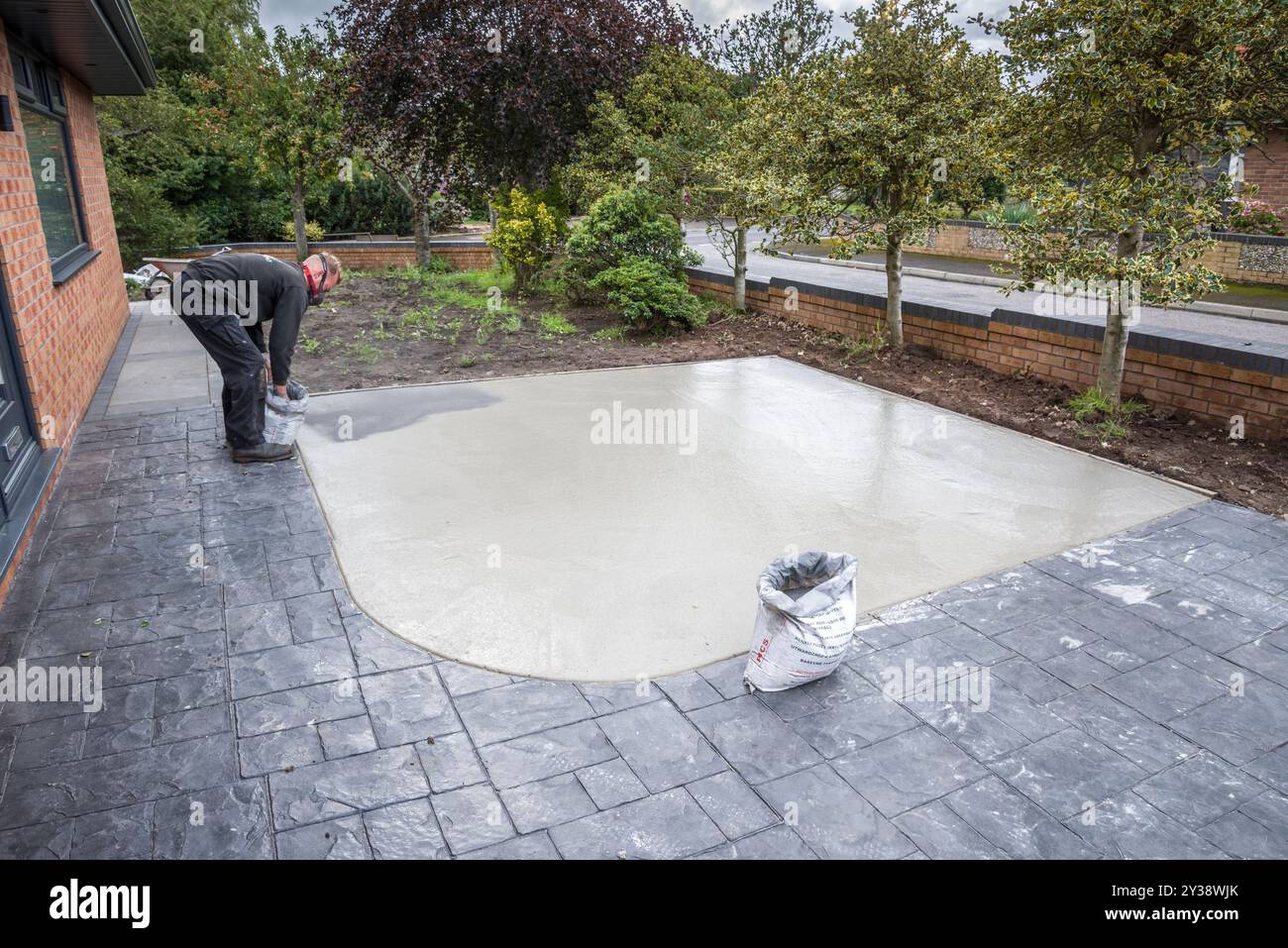 work men pouring concrete creating a new concrete driveway Stock Photo ...