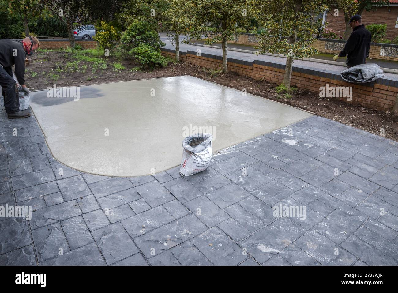 work men pouring concrete creating a new concrete driveway Stock Photo ...