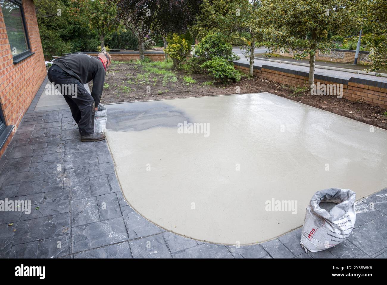 work men pouring concrete creating a new concrete driveway Stock Photo ...