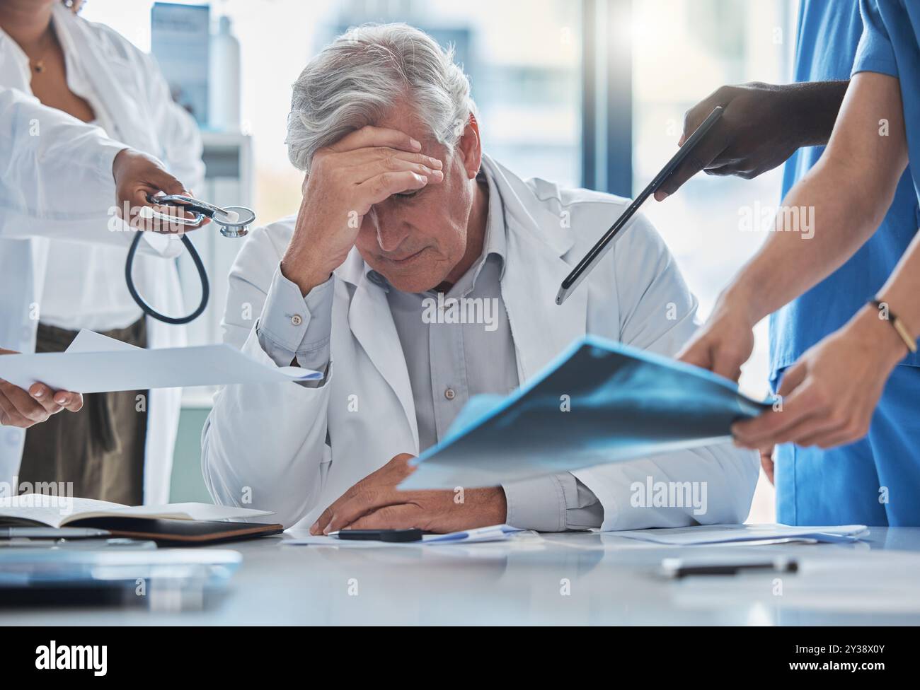 Mature, doctor and stress of team in office with multitasking, time ...