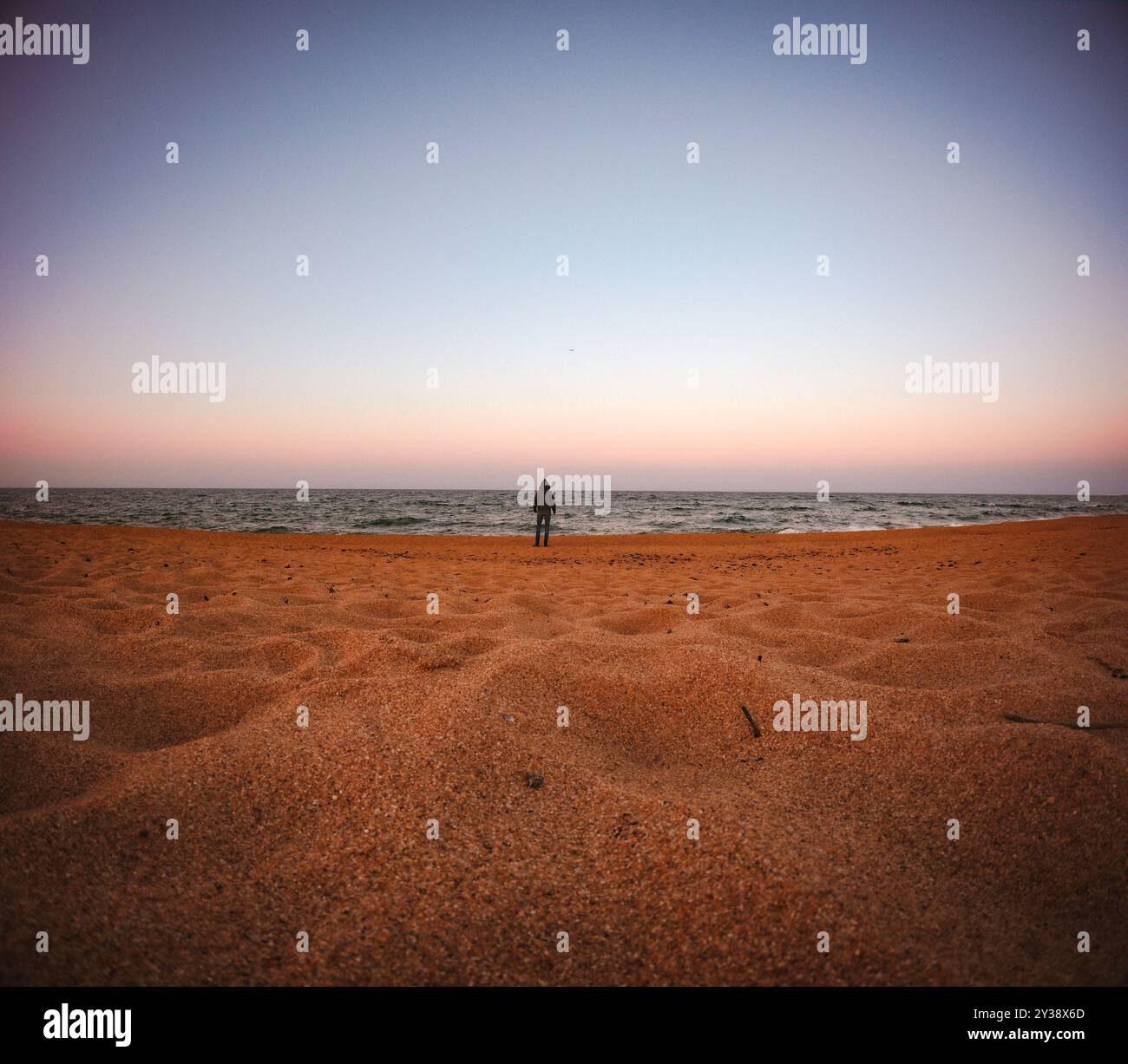 The smallness of man. Unrecognizable person standing on beach in front ...