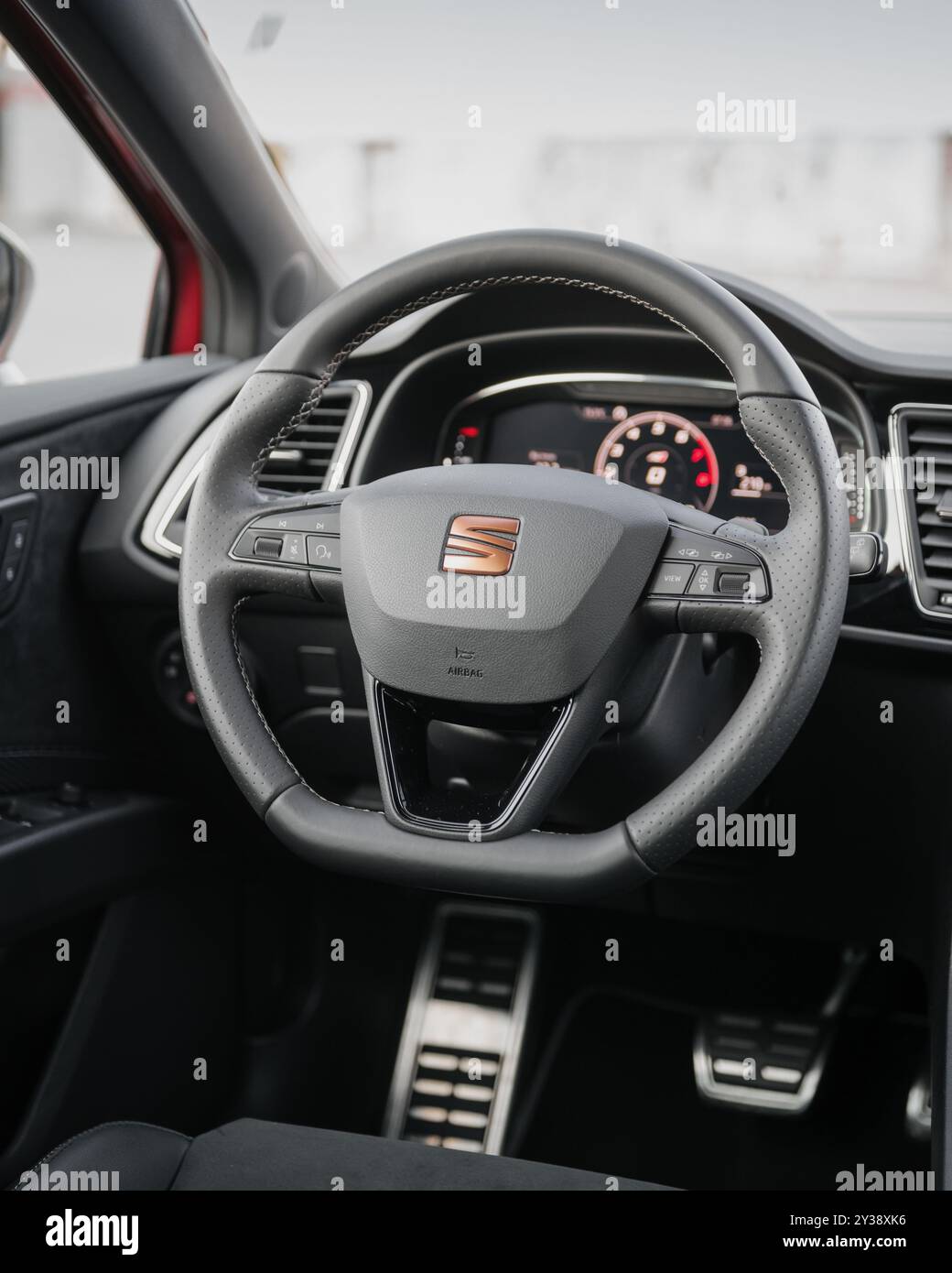 interior of Leon Cupra. Close-up view of steering wheel and dashboard ...