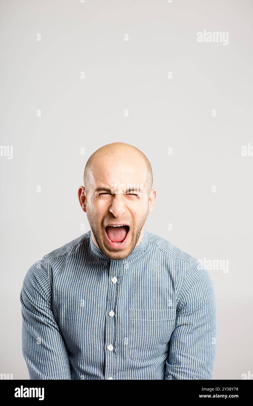 Shouting, screaming and portrait of angry man in studio with anger ...