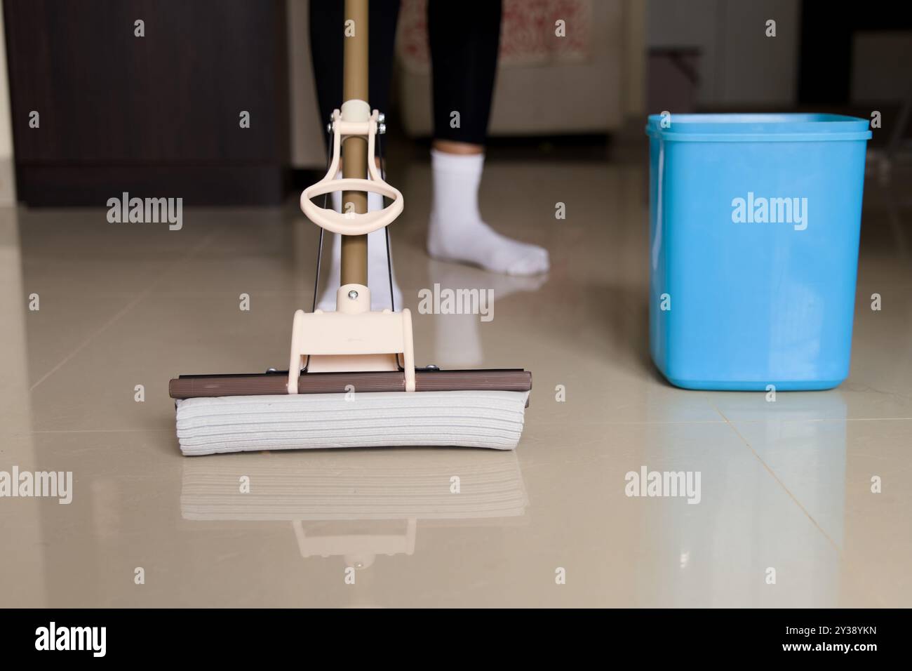 A modern floor cleaning setup showcasing a mop and bucket. The scene ...