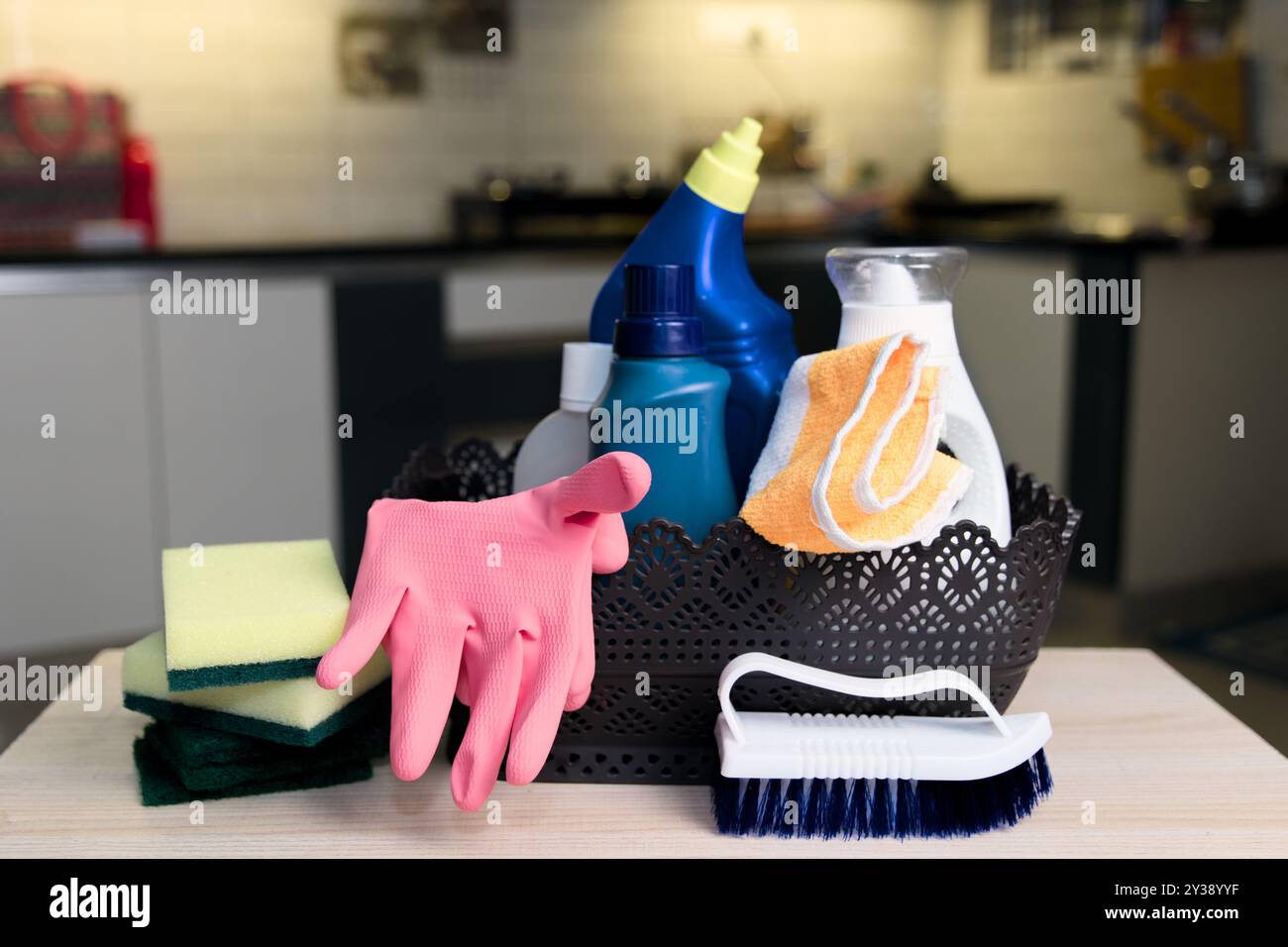A collection of essential cleaning supplies including sponges, gloves ...