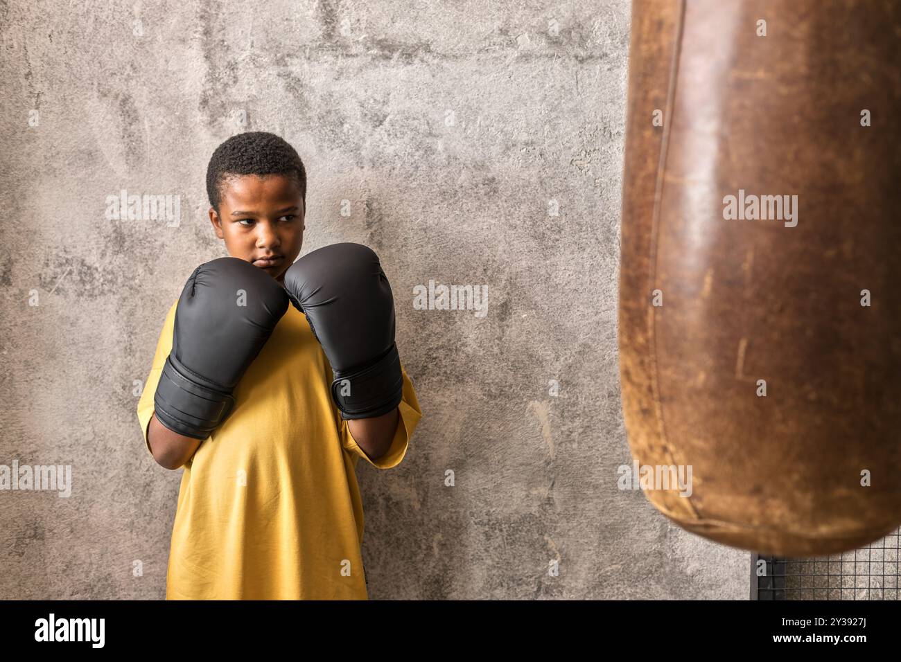 Boxing kid boy punching bag hi-res stock photography and images - Alamy
