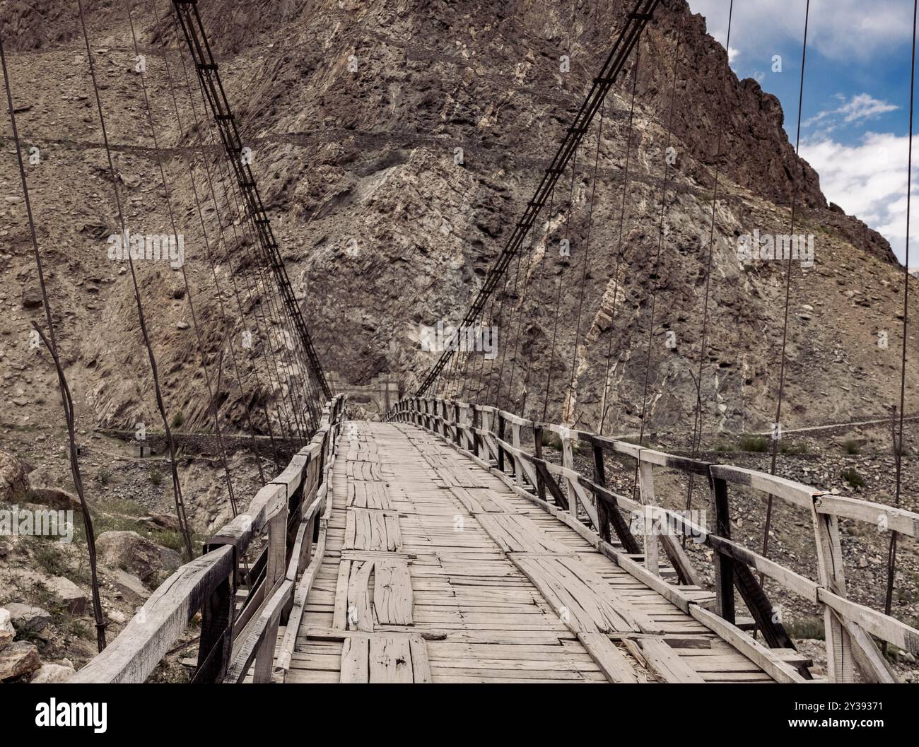 A typical Pakistan bridge is built over a rocky mountain Stock Photo ...