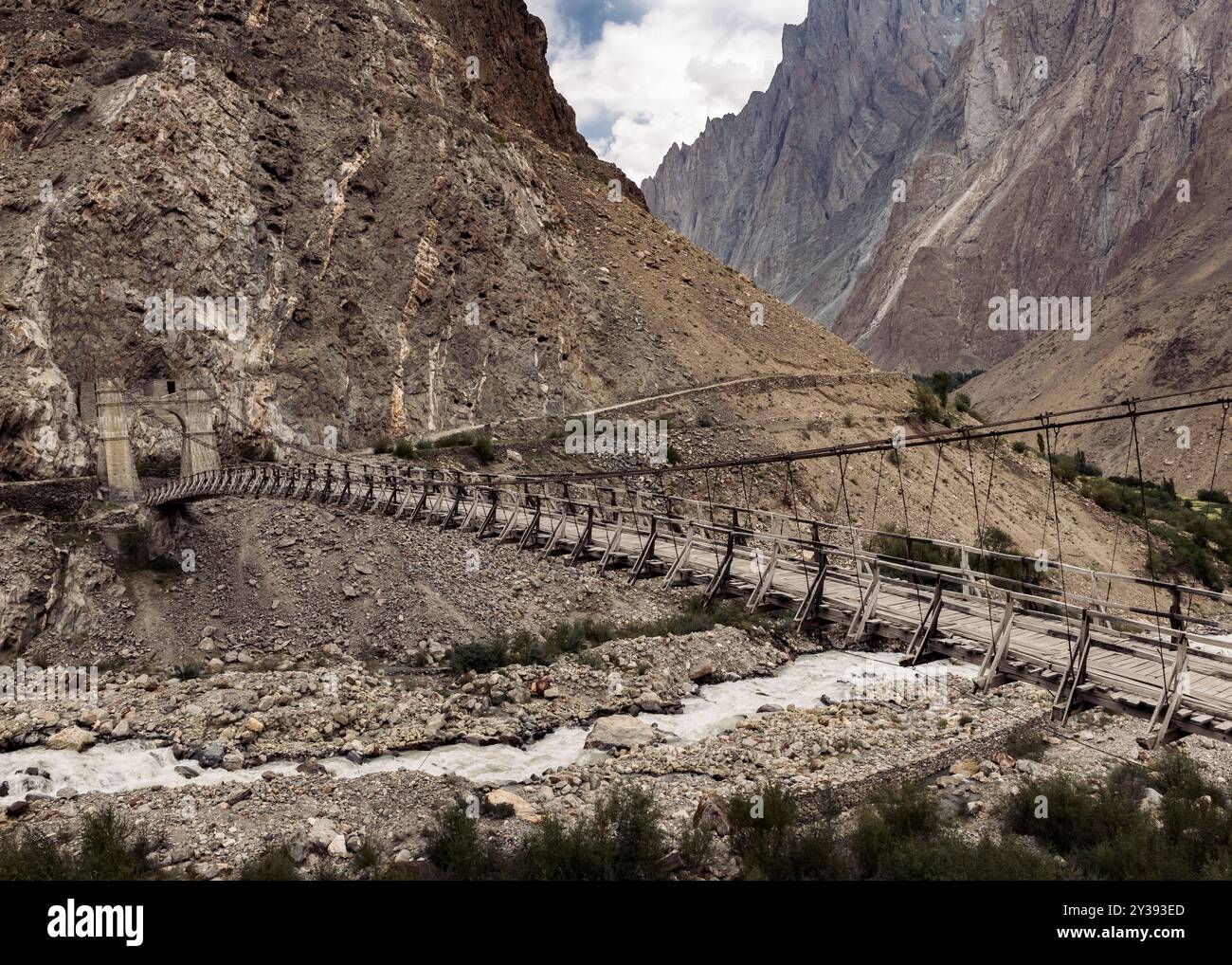 A typical Pakistan bridge is built over a rocky mountain Stock Photo ...