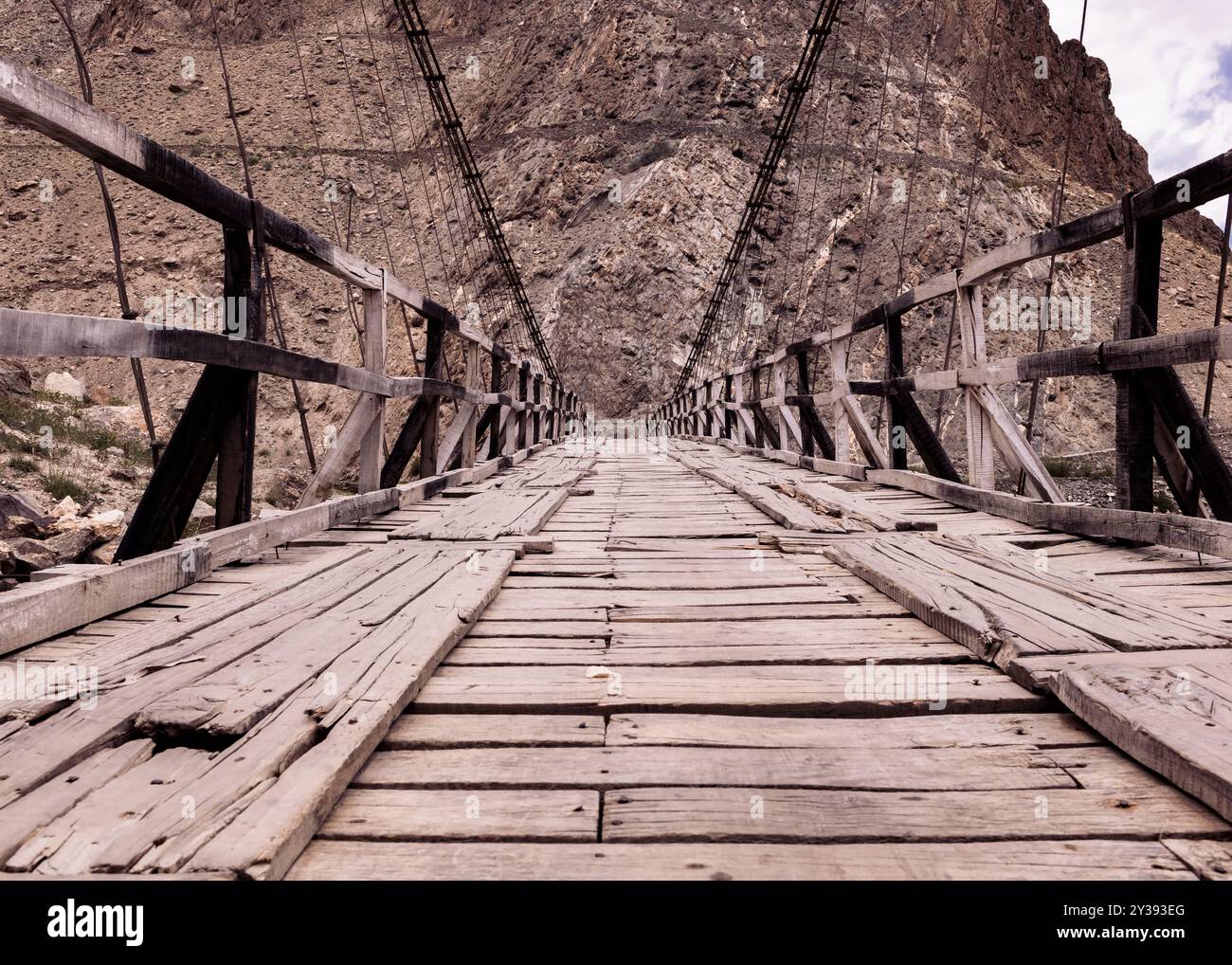A typical Pakistan bridge is built over a rocky mountain Stock Photo ...