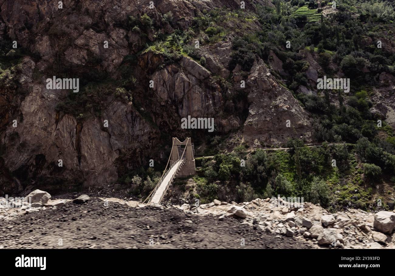 A typical Pakistan bridge is built over a rocky mountain Stock Photo ...