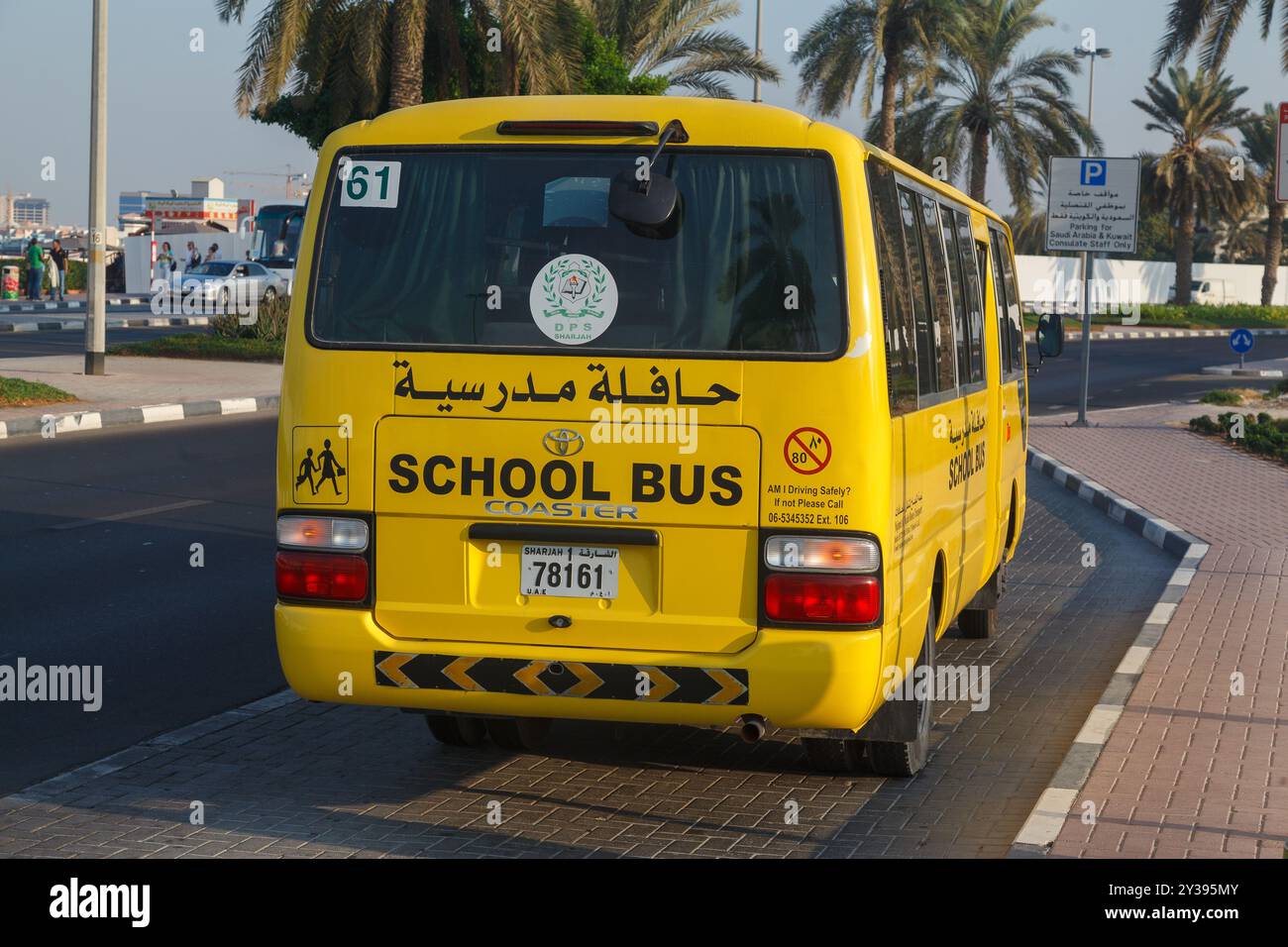 A typical yellow school bus with arabic writing in Dubai, United Arab ...