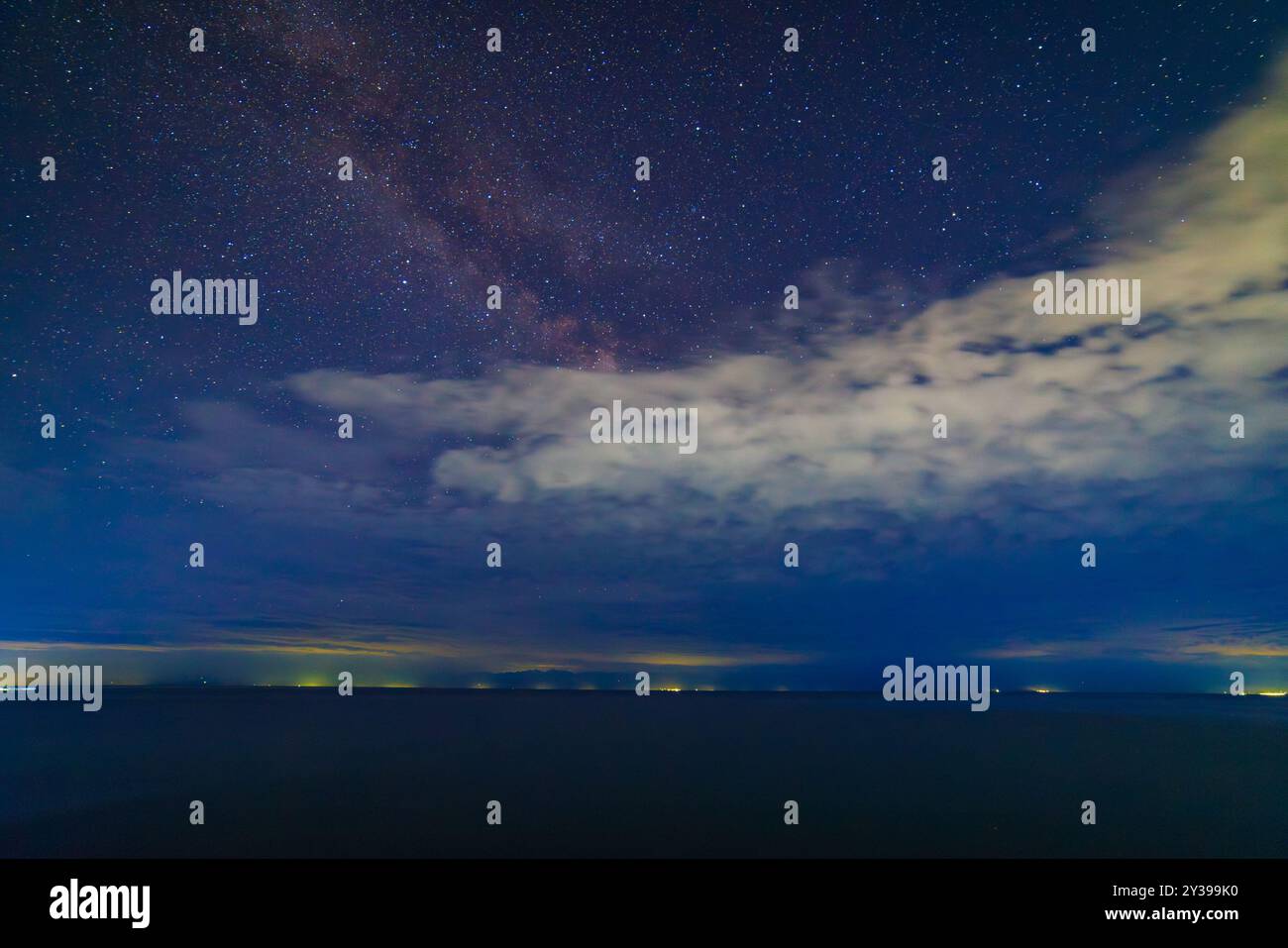 starry night sky over large mountain lake at night Stock Photo - Alamy