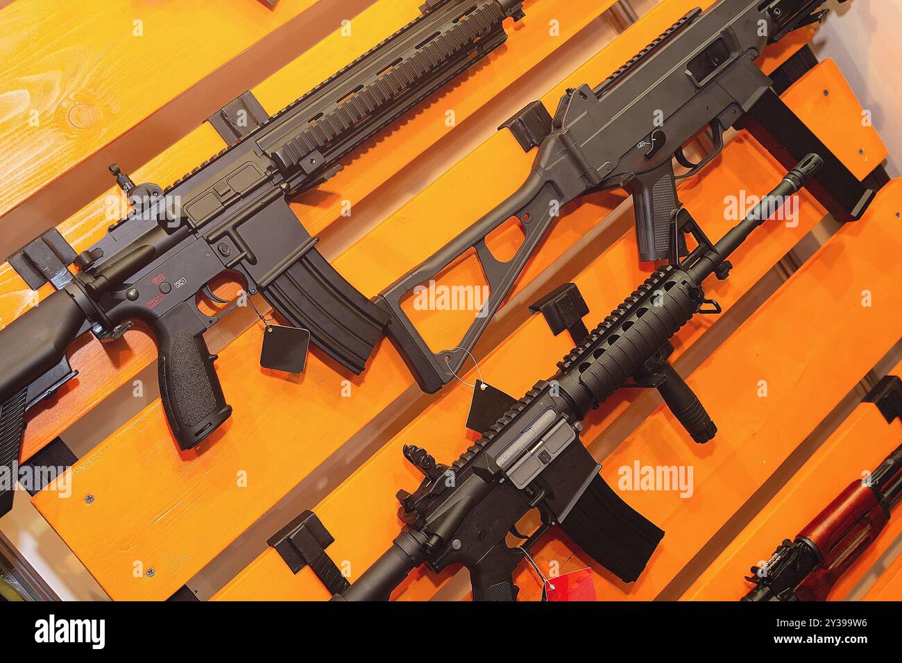 Automatic rifle hanging on the stand in the store. Weapon Stock Photo ...