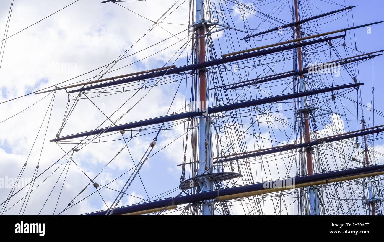 Shkots, halyards, braces on ship mast, blue sky and sea background ...