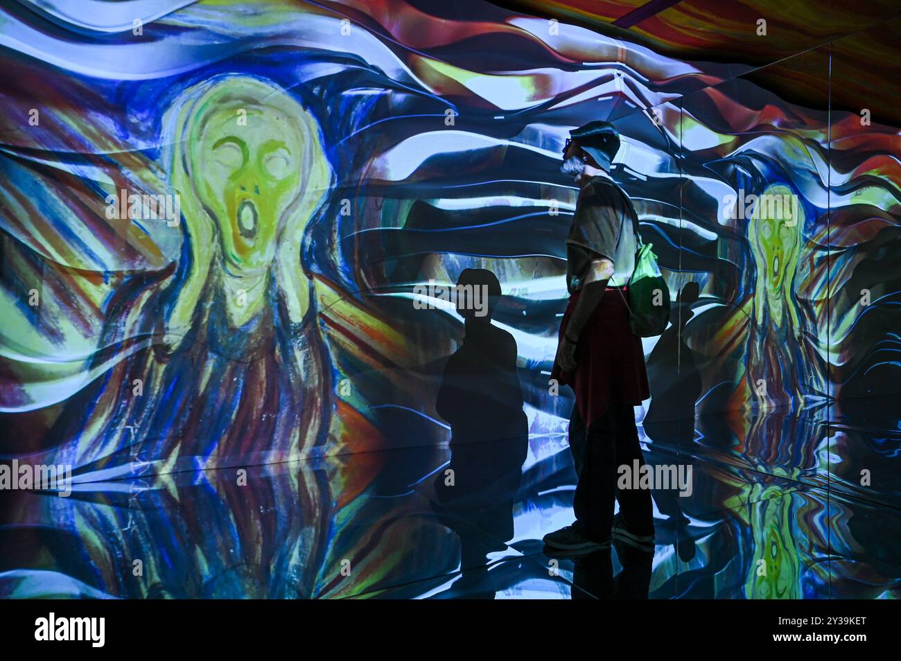 A visitor reacts next to an immersive projection of 'The Scream' during ...