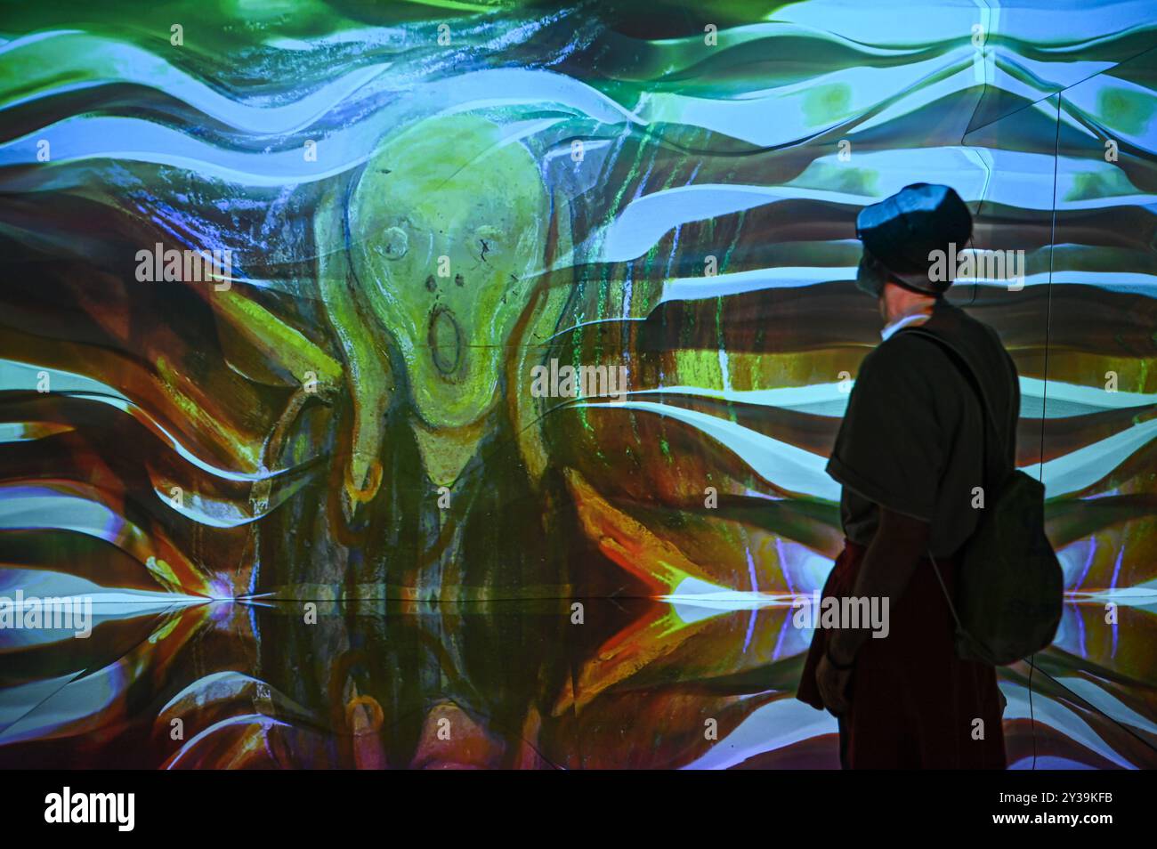 A visitor reacts next to an immersive projection of 'The Scream' during ...