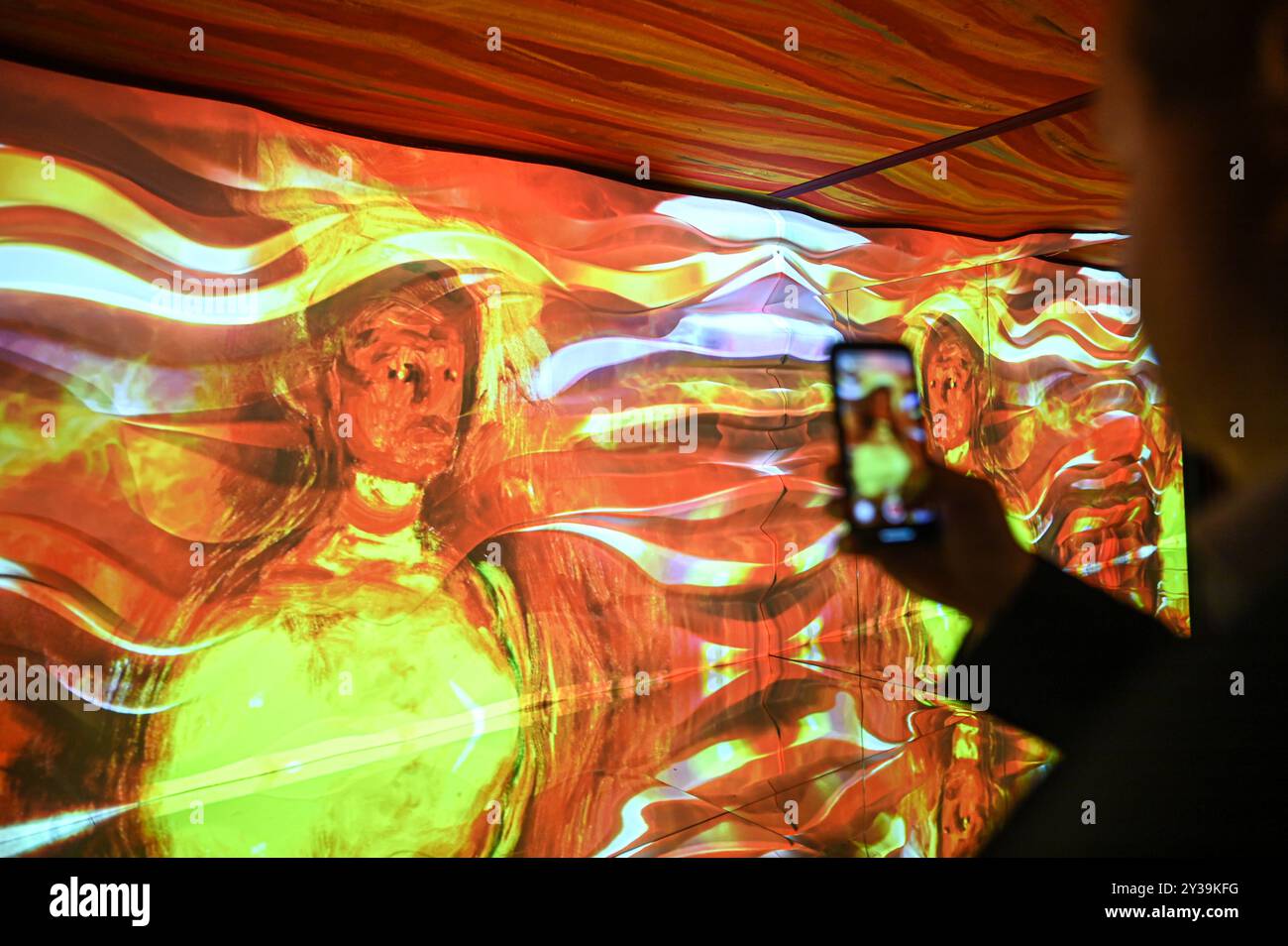 A visitor takes a photo to to an immersive projection of 'Self-Portrait ...
