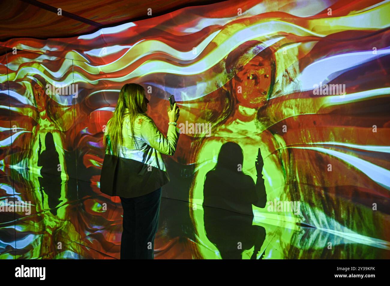 A visitor looks to an immersive projection of 'Self-Portrait in Hell ...